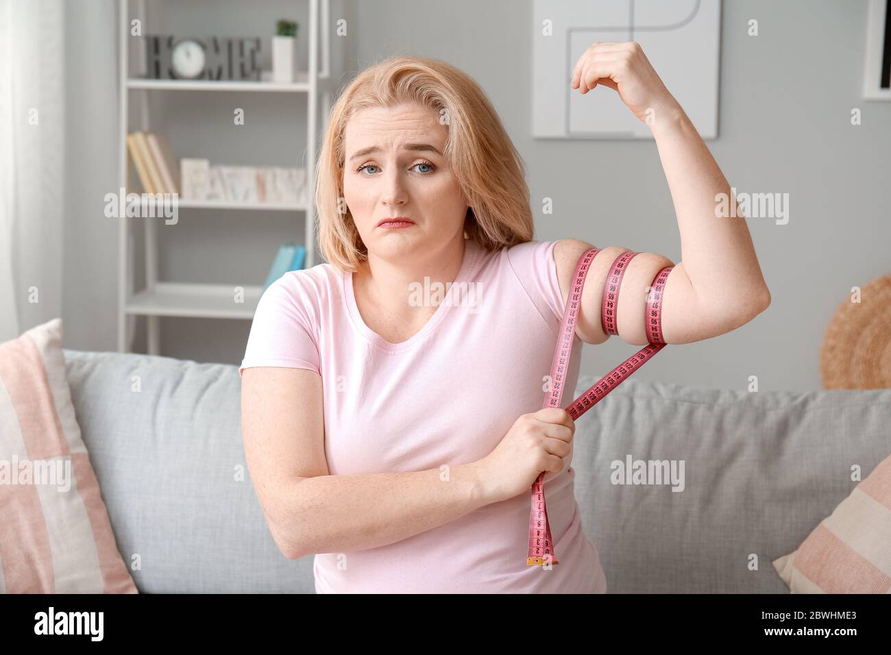 Woman measuring excess arm hi-res stock photography and images - Alamy