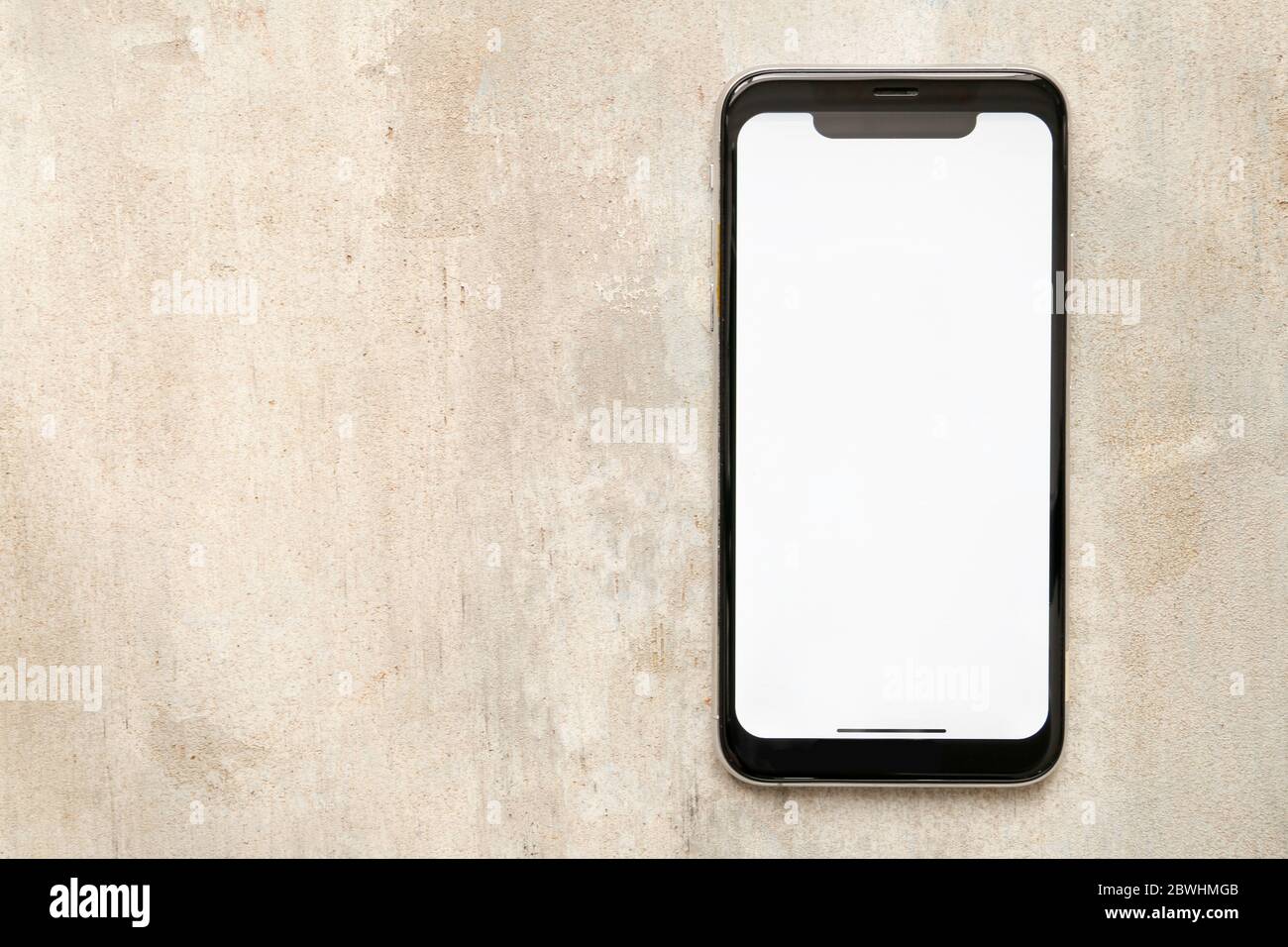 Modern mobile phone on grey background Stock Photo - Alamy