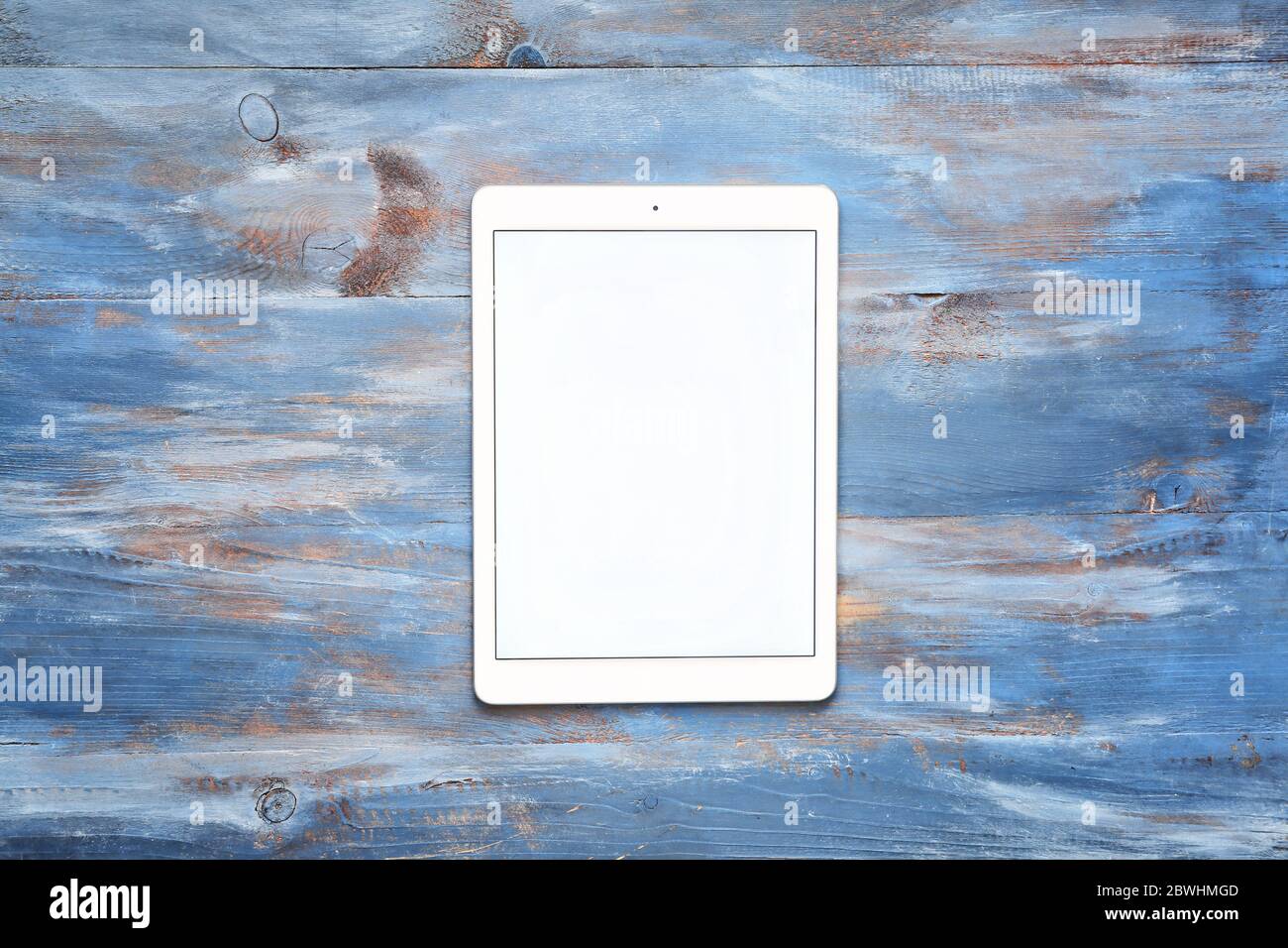 Modern tablet computer on color wooden background Stock Photo - Alamy