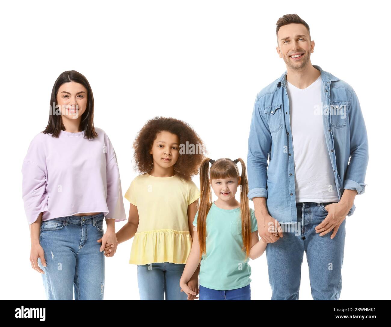 Happy couple with little adopted children on white background Stock ...