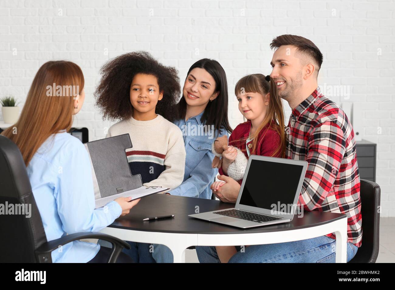 Social worker meeting with couple for signing adoption documents Stock ...