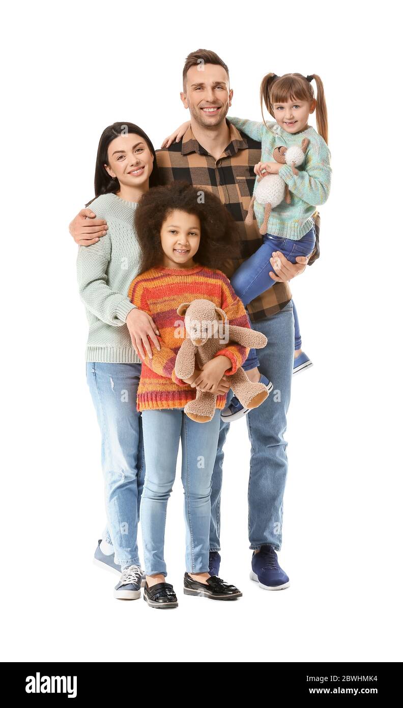 Happy couple with little adopted children on white background Stock ...