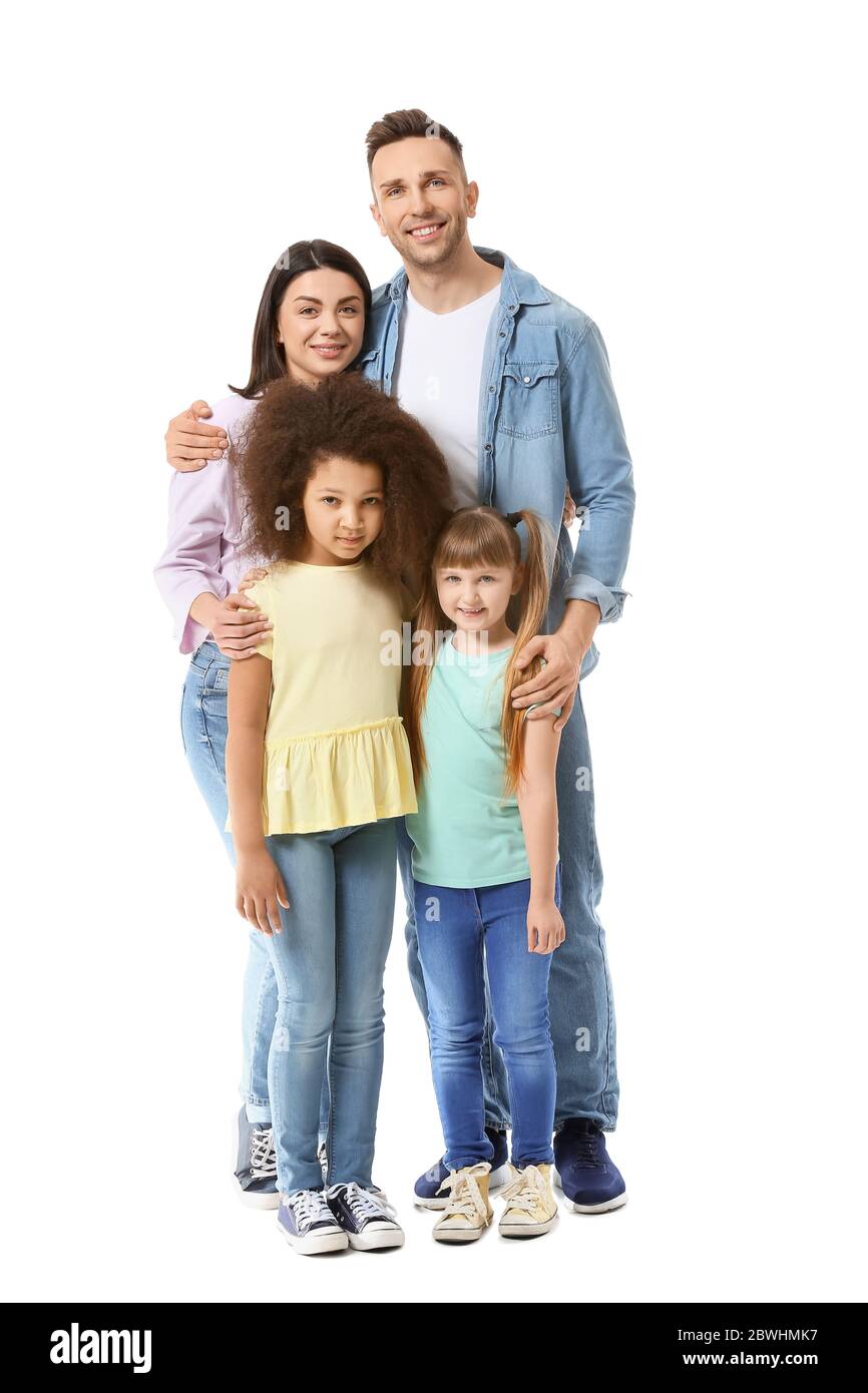 Happy couple with little adopted children on white background Stock ...