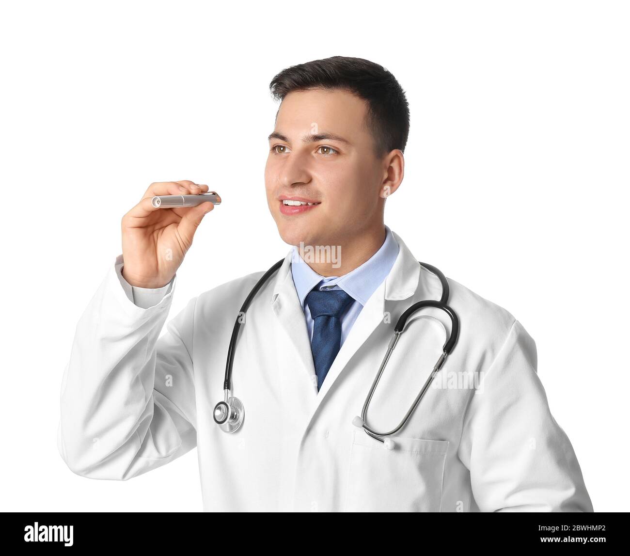 Male doctor with flashlight on white background Stock Photo - Alamy