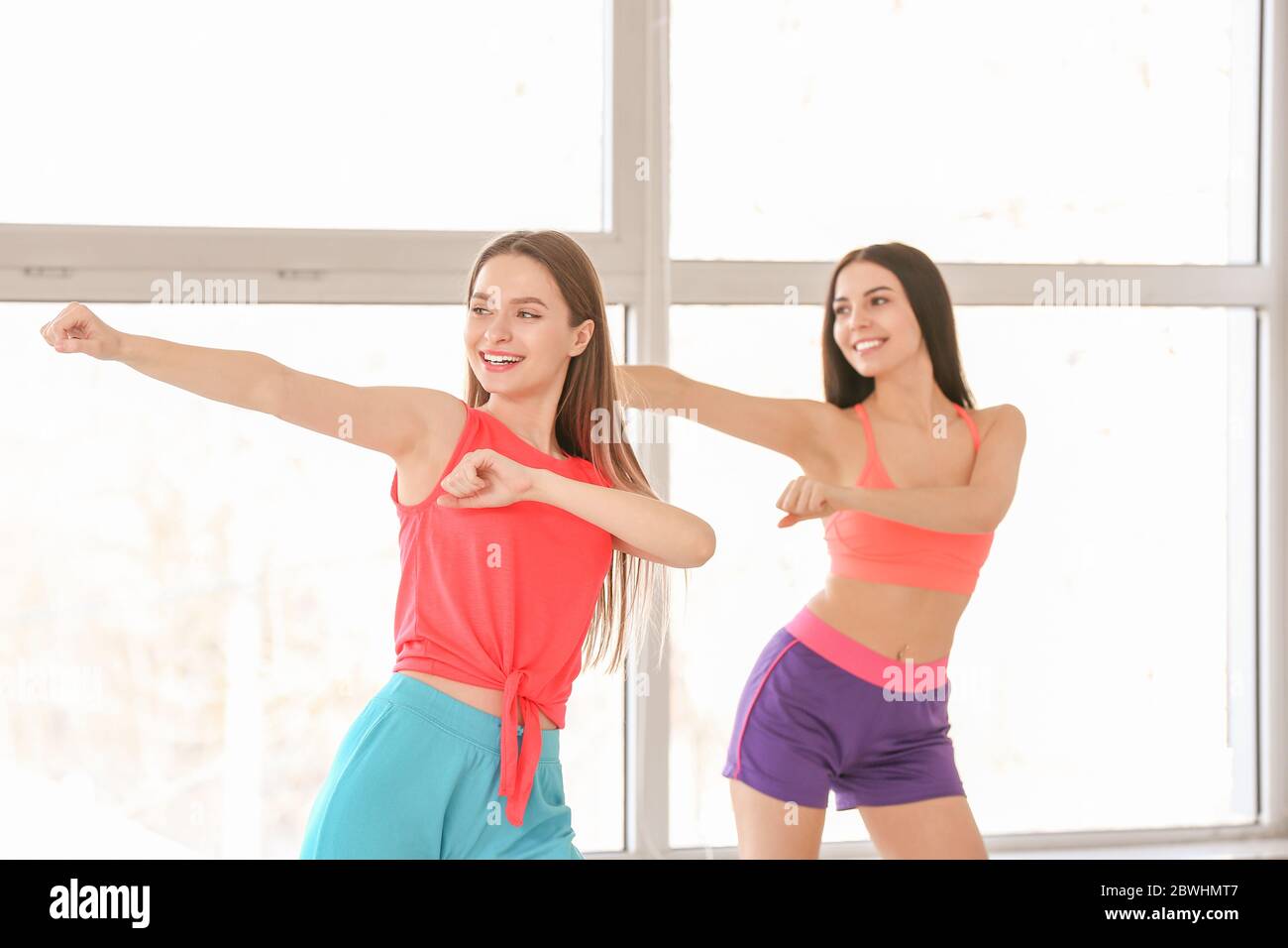 Beautiful young women dancing in studio Stock Photo - Alamy
