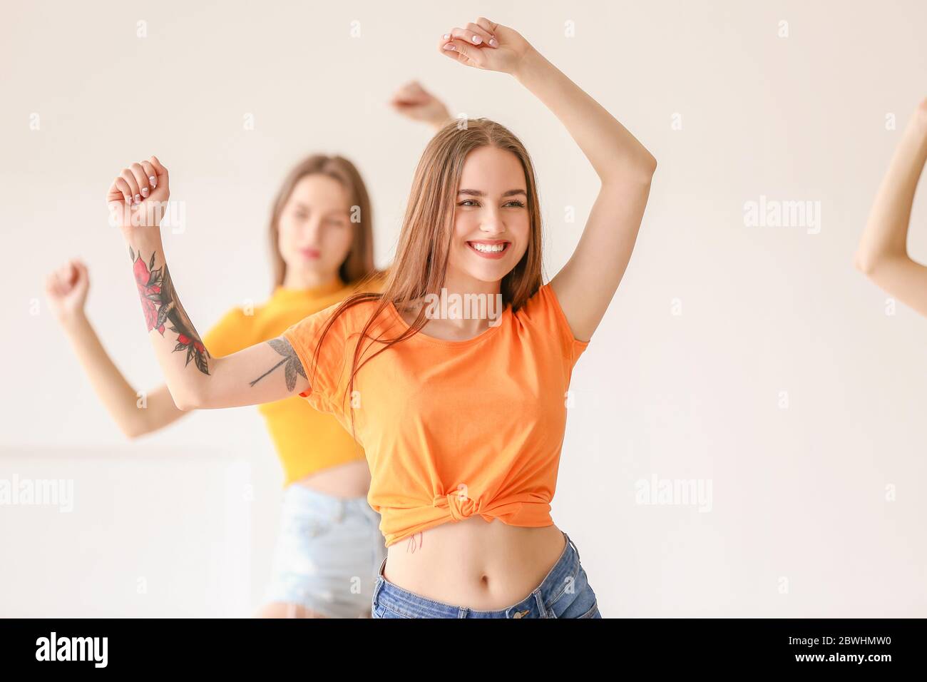 Beautiful young women dancing in studio Stock Photo - Alamy