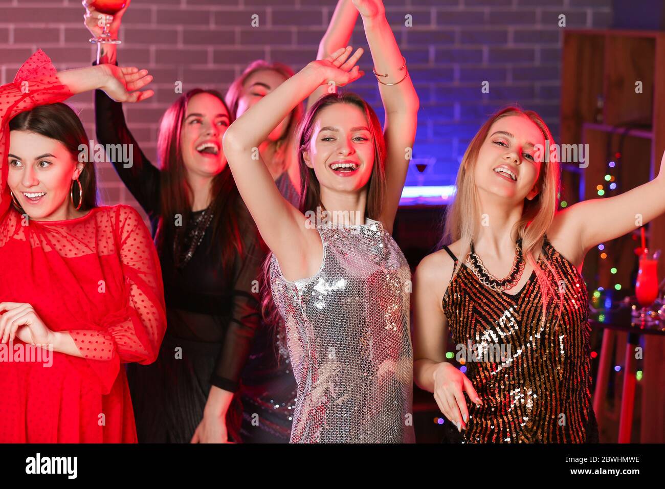 Beautiful young women dancing in night club Stock Photo - Alamy