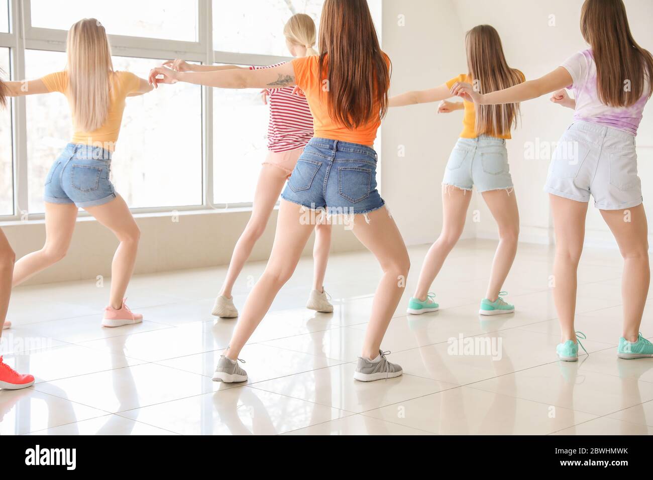 Beautiful young women dancing in studio Stock Photo - Alamy
