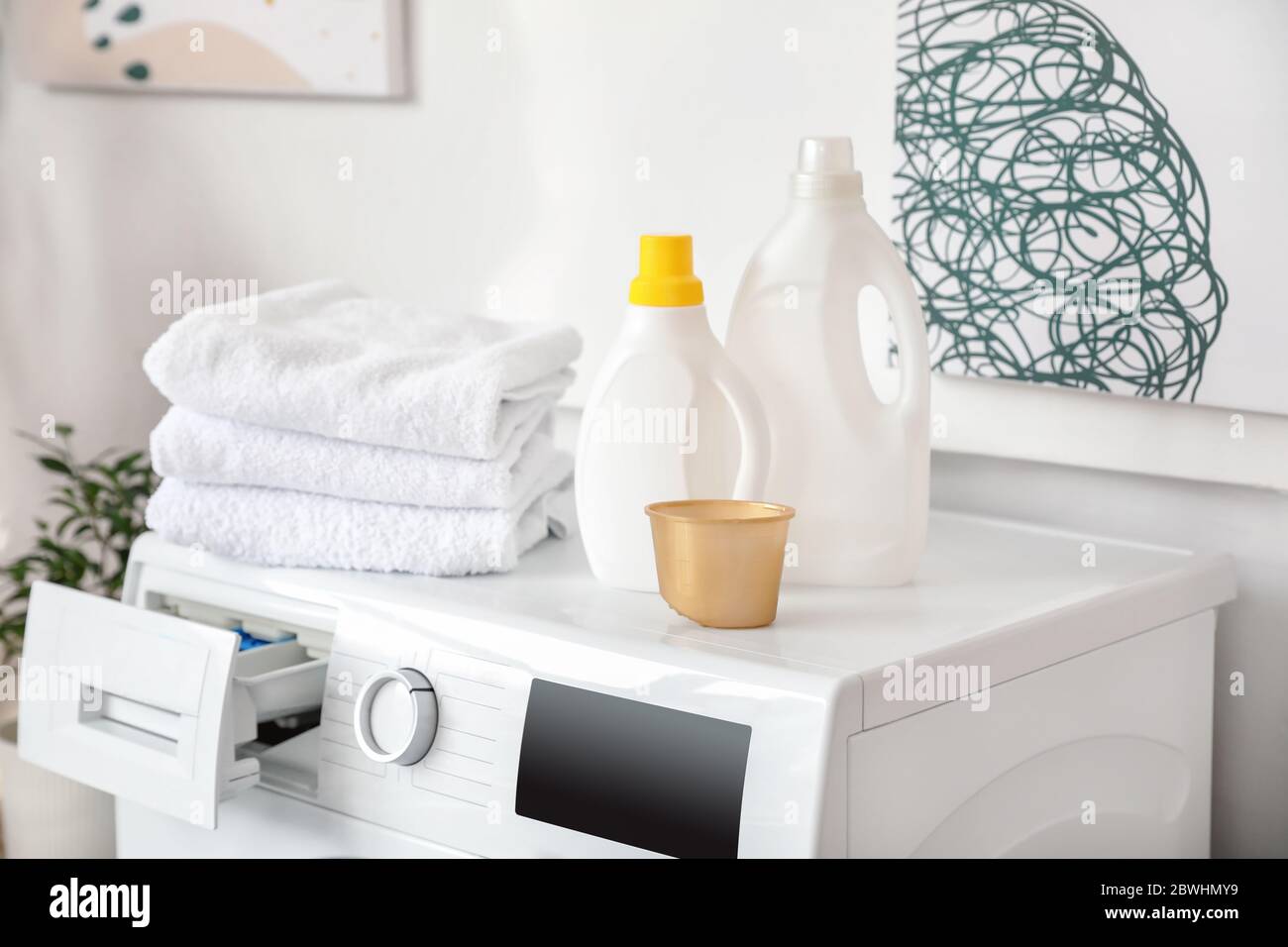 Detergents and laundry on washing machine Stock Photo - Alamy