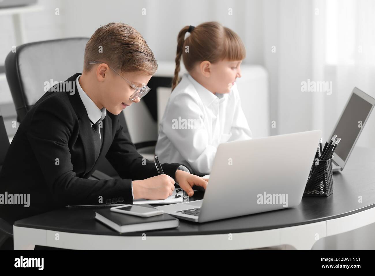 Little secretaries working in office Stock Photo - Alamy