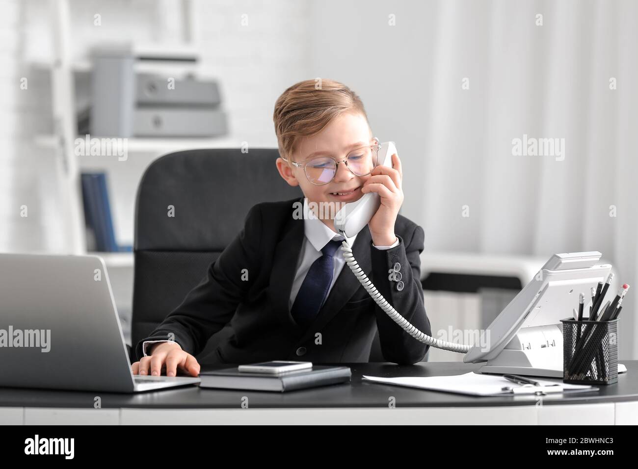 Little secretary working in office Stock Photo - Alamy