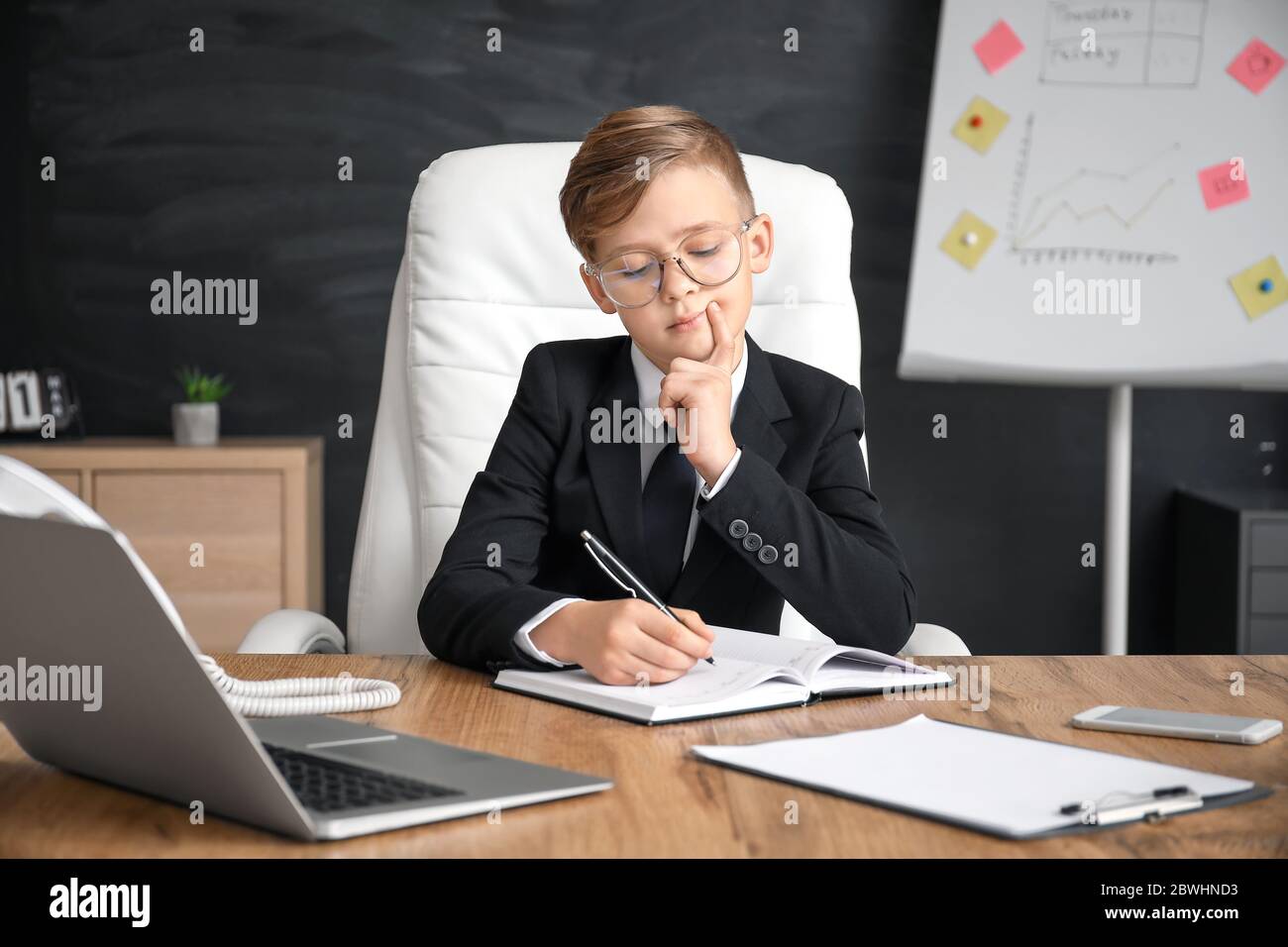 Little secretary working in office Stock Photo - Alamy