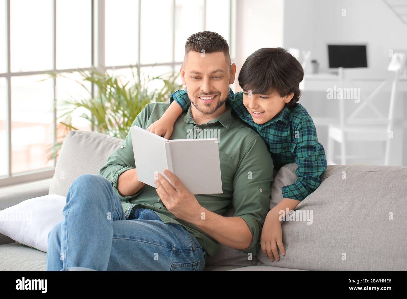 Father and little son reading book at home Stock Photo - Alamy