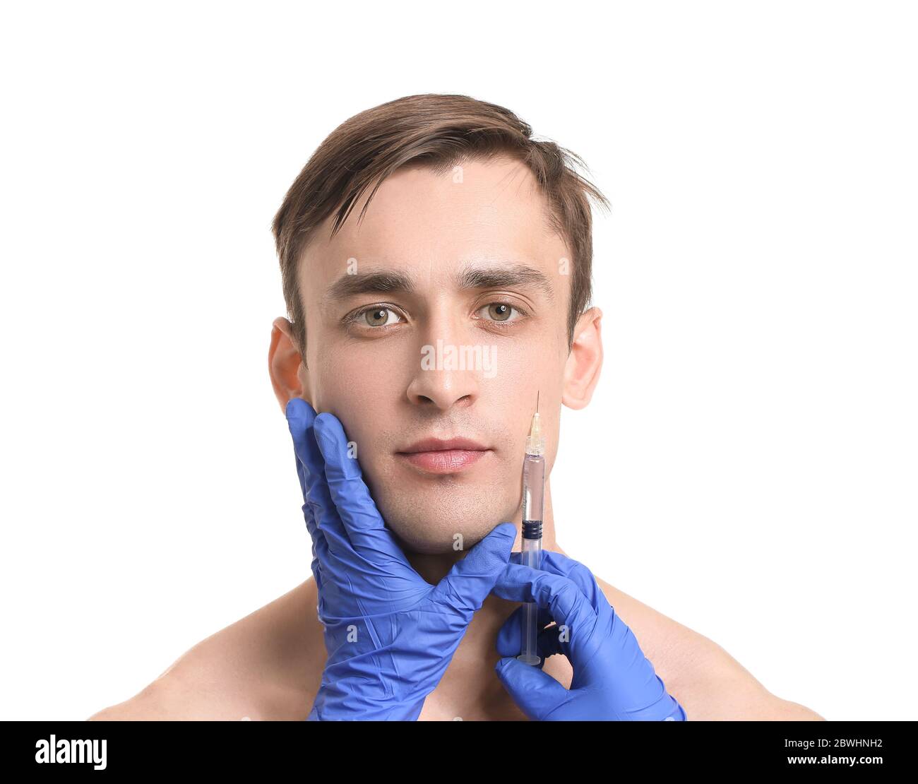 Handsome man receiving filler injection on white background Stock Photo ...