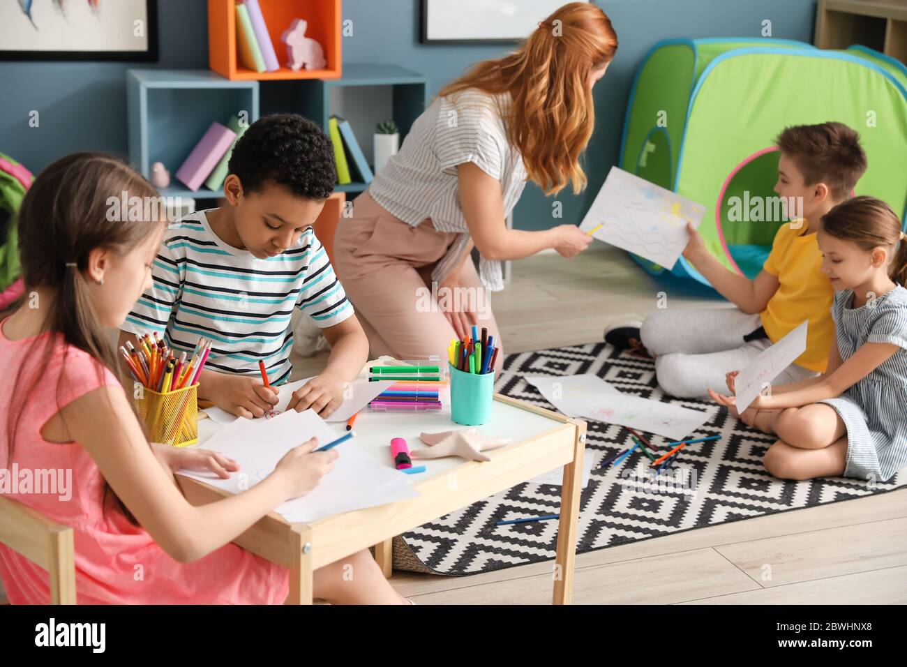 Cute children drawing at school Stock Photo - Alamy
