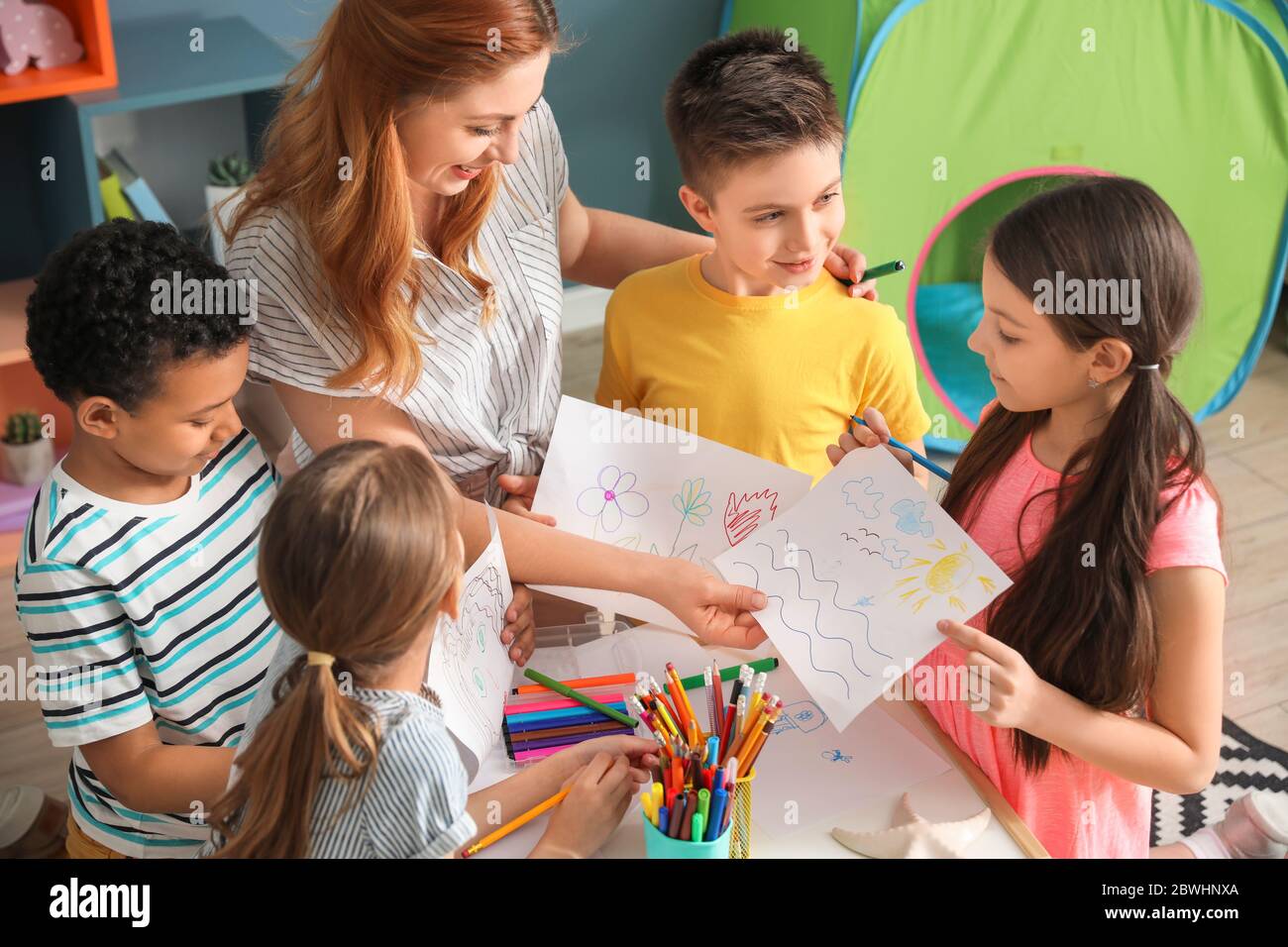 Education teacher giving kid paper hi-res stock photography and images ...