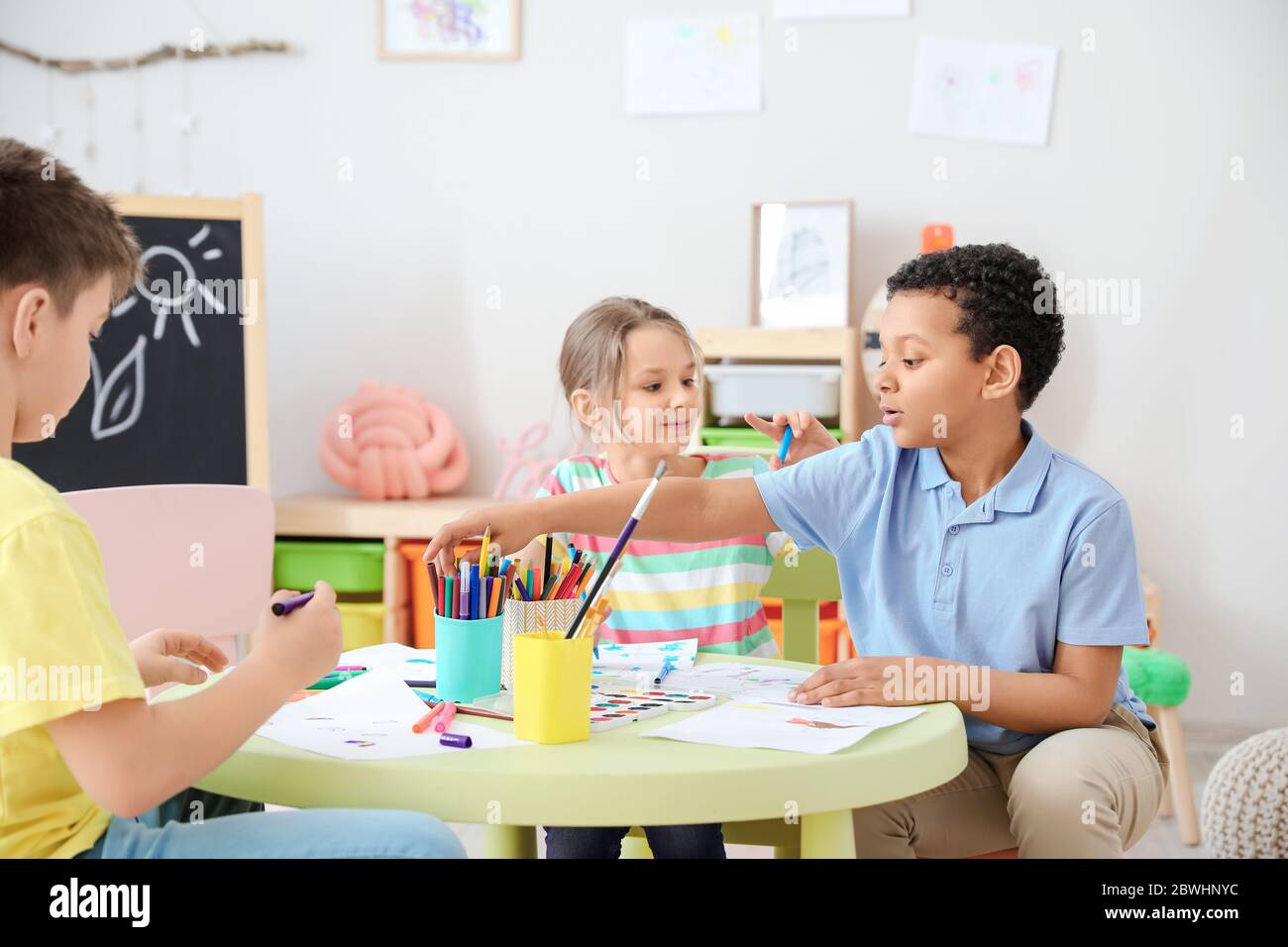 Cute children drawing at school Stock Photo - Alamy