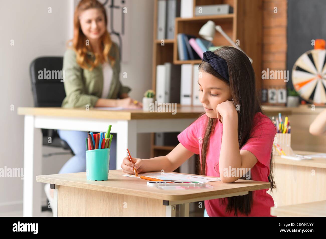 Cute girl drawing at school Stock Photo - Alamy