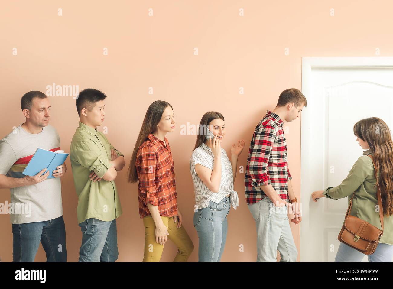 People waiting in line indoors Stock Photo - Alamy