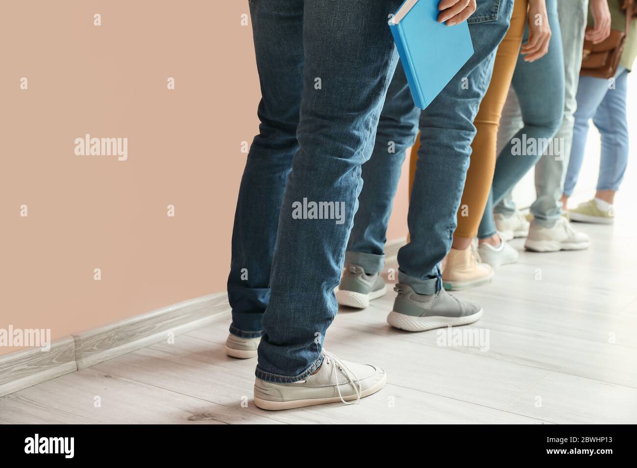 People waiting in line indoors Stock Photo - Alamy