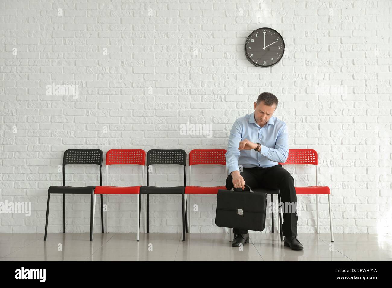 Man waiting for his turn indoors Stock Photo - Alamy