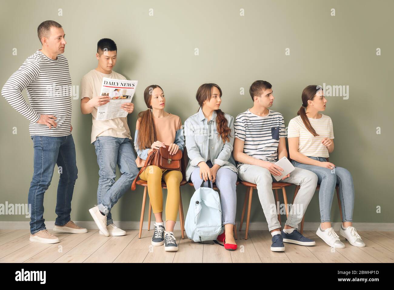 People waiting in line indoors Stock Photo - Alamy