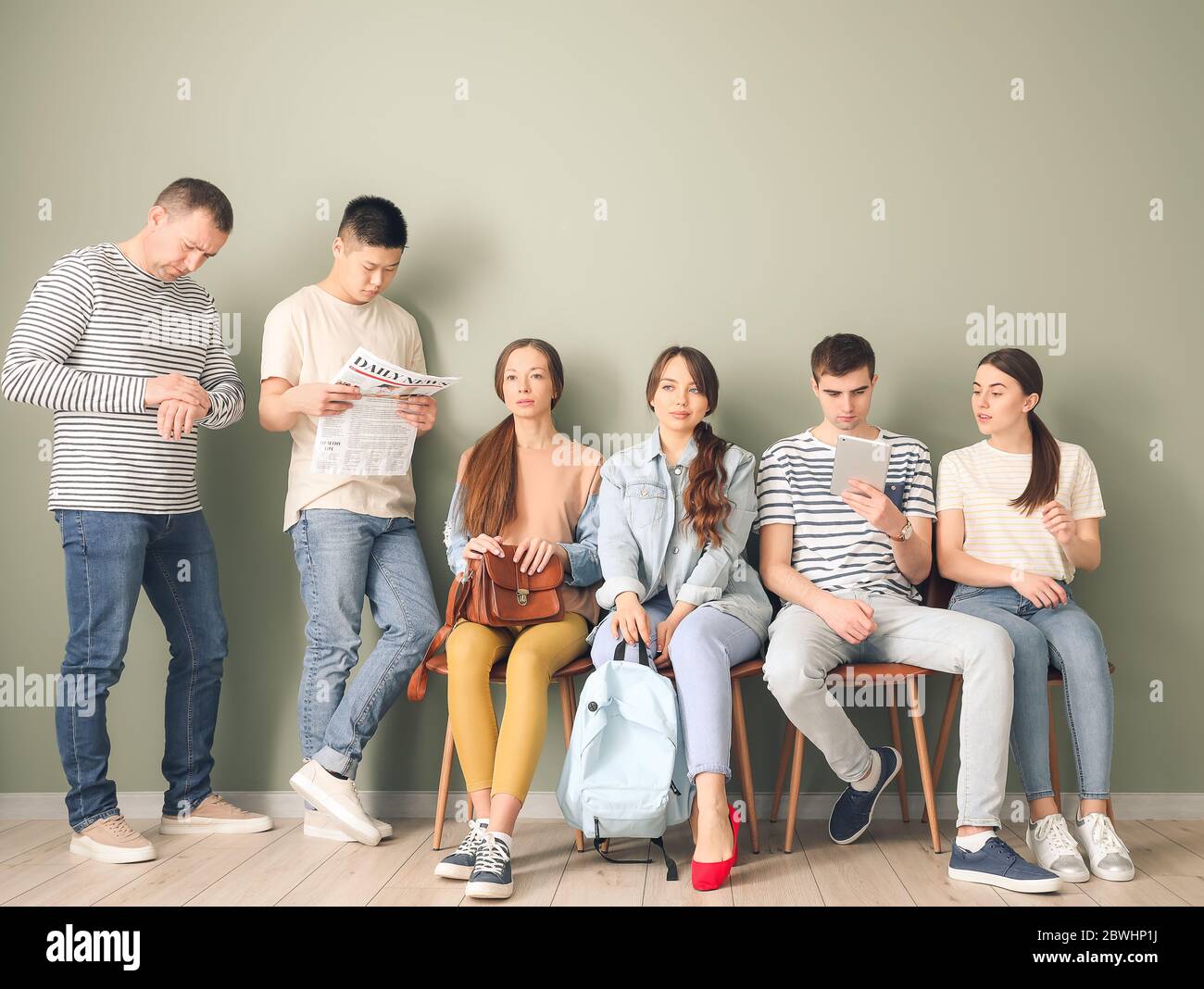 People waiting in line indoors Stock Photo - Alamy