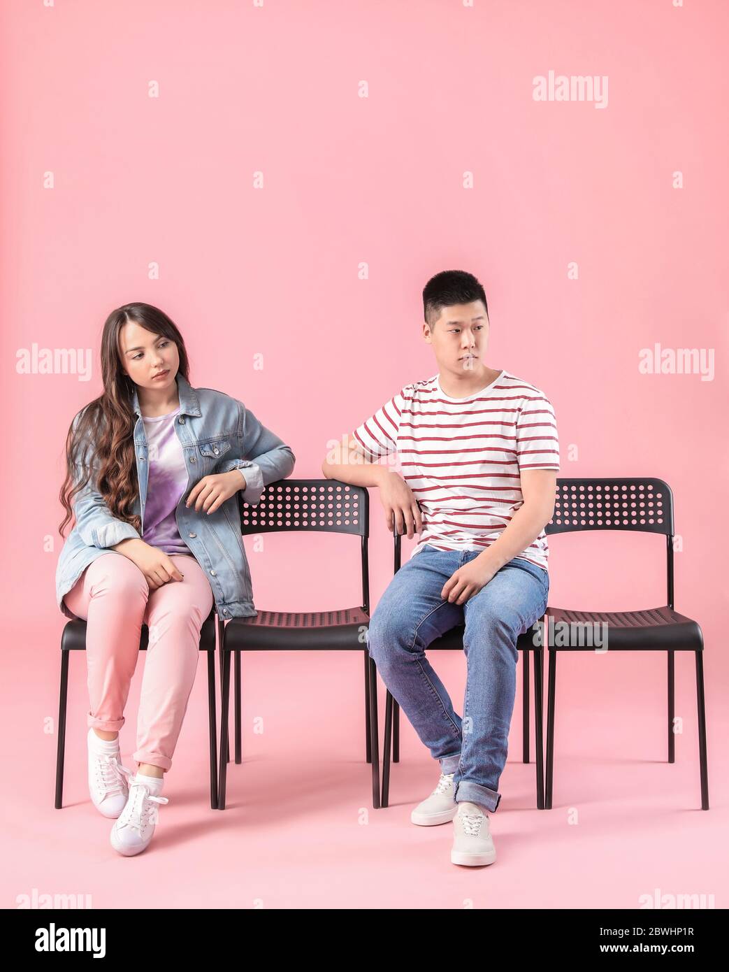 People waiting in line on color background Stock Photo - Alamy