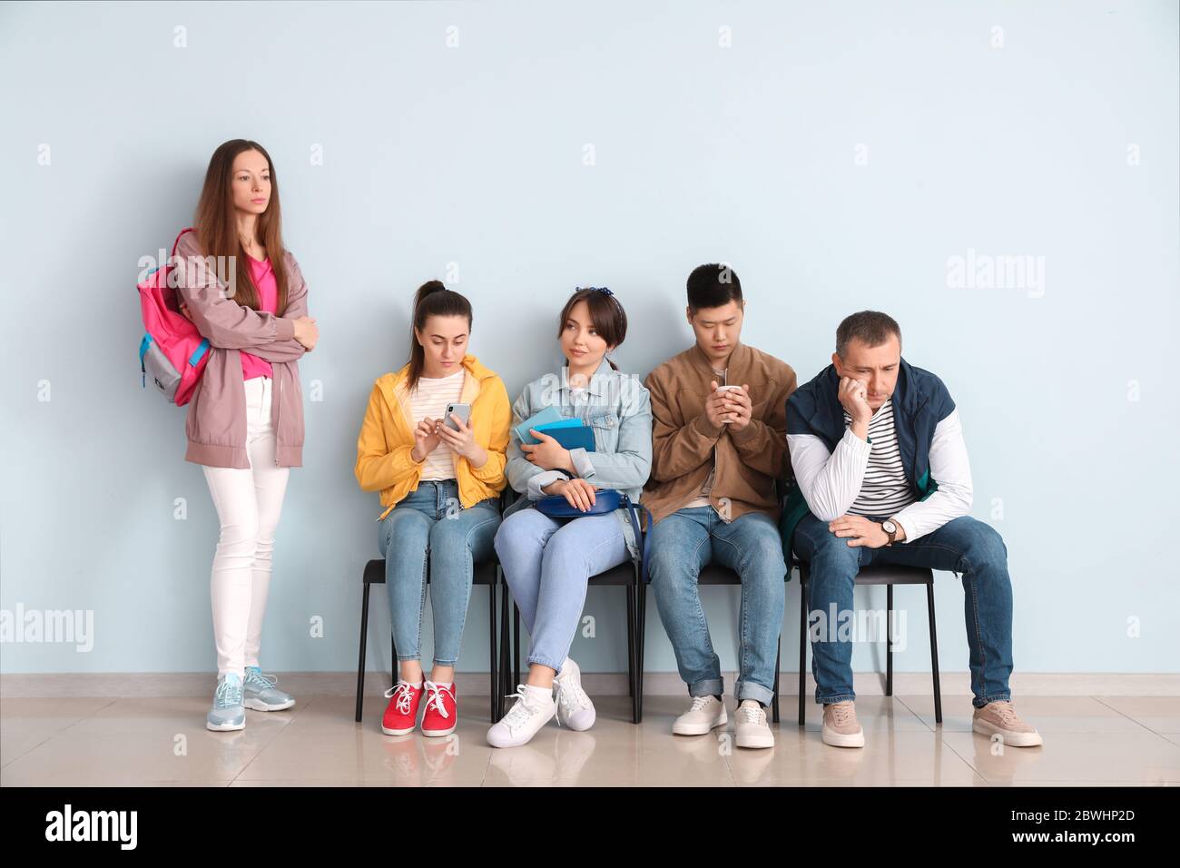 People waiting in line indoors Stock Photo - Alamy