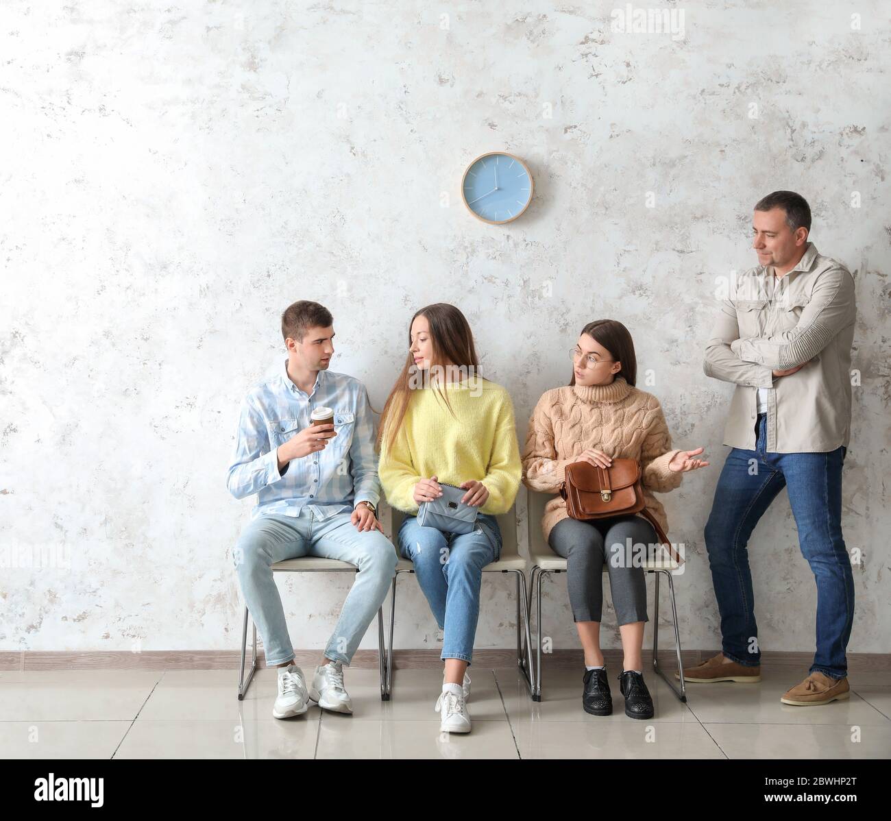 People waiting in line indoors Stock Photo - Alamy