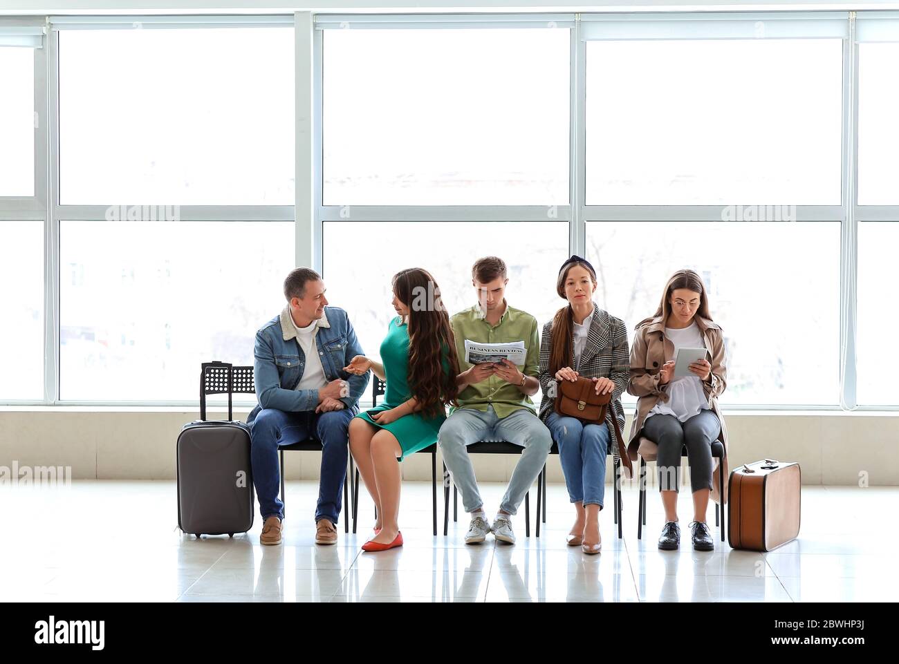 People waiting in line at the airport Stock Photo - Alamy