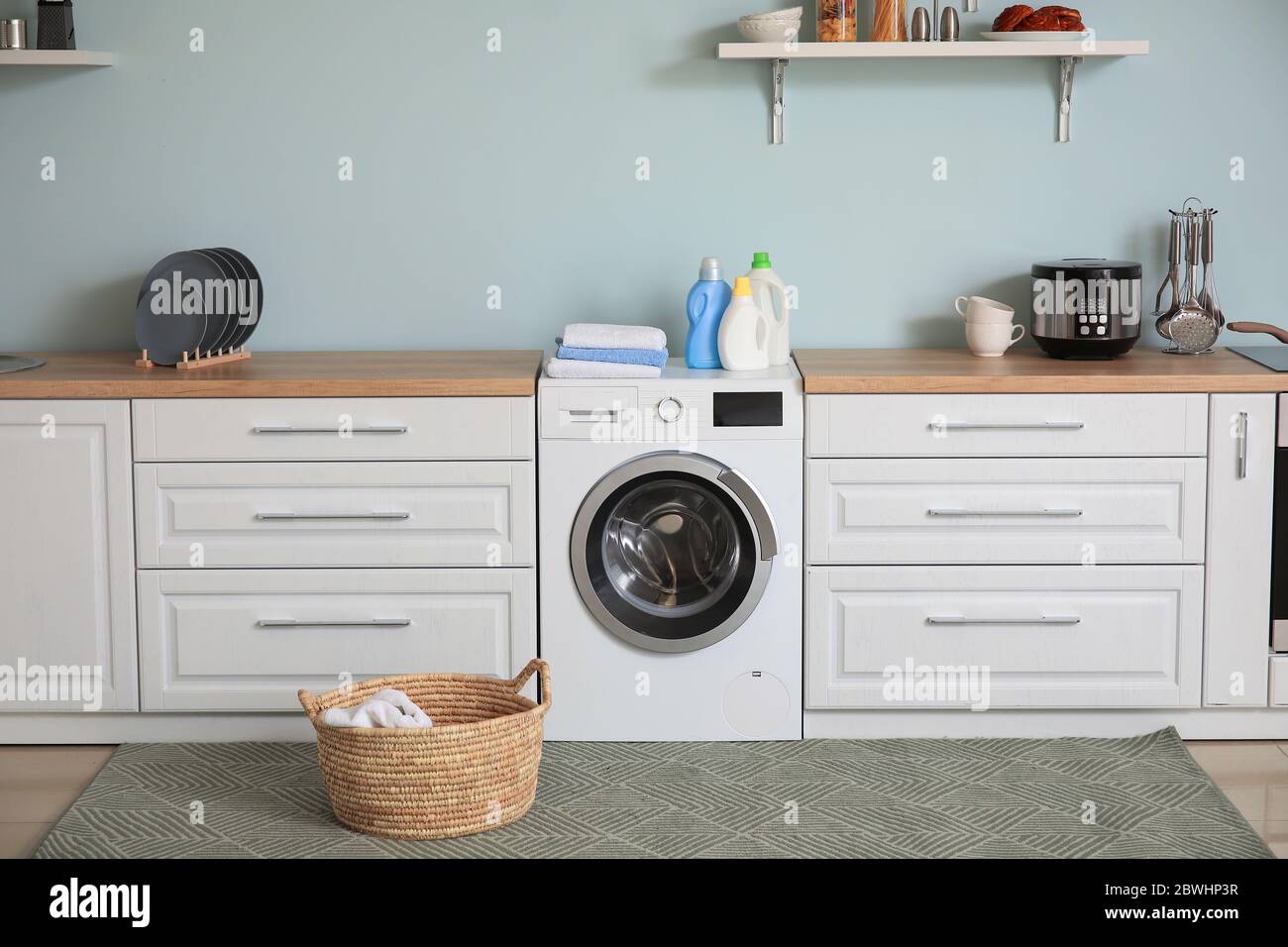 Interior of kitchen with modern washing machine Stock Photo - Alamy