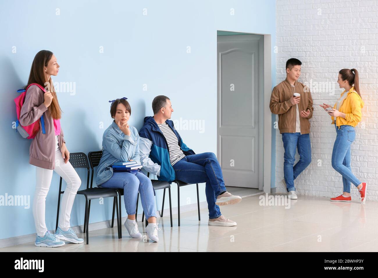 People waiting in line indoors Stock Photo - Alamy