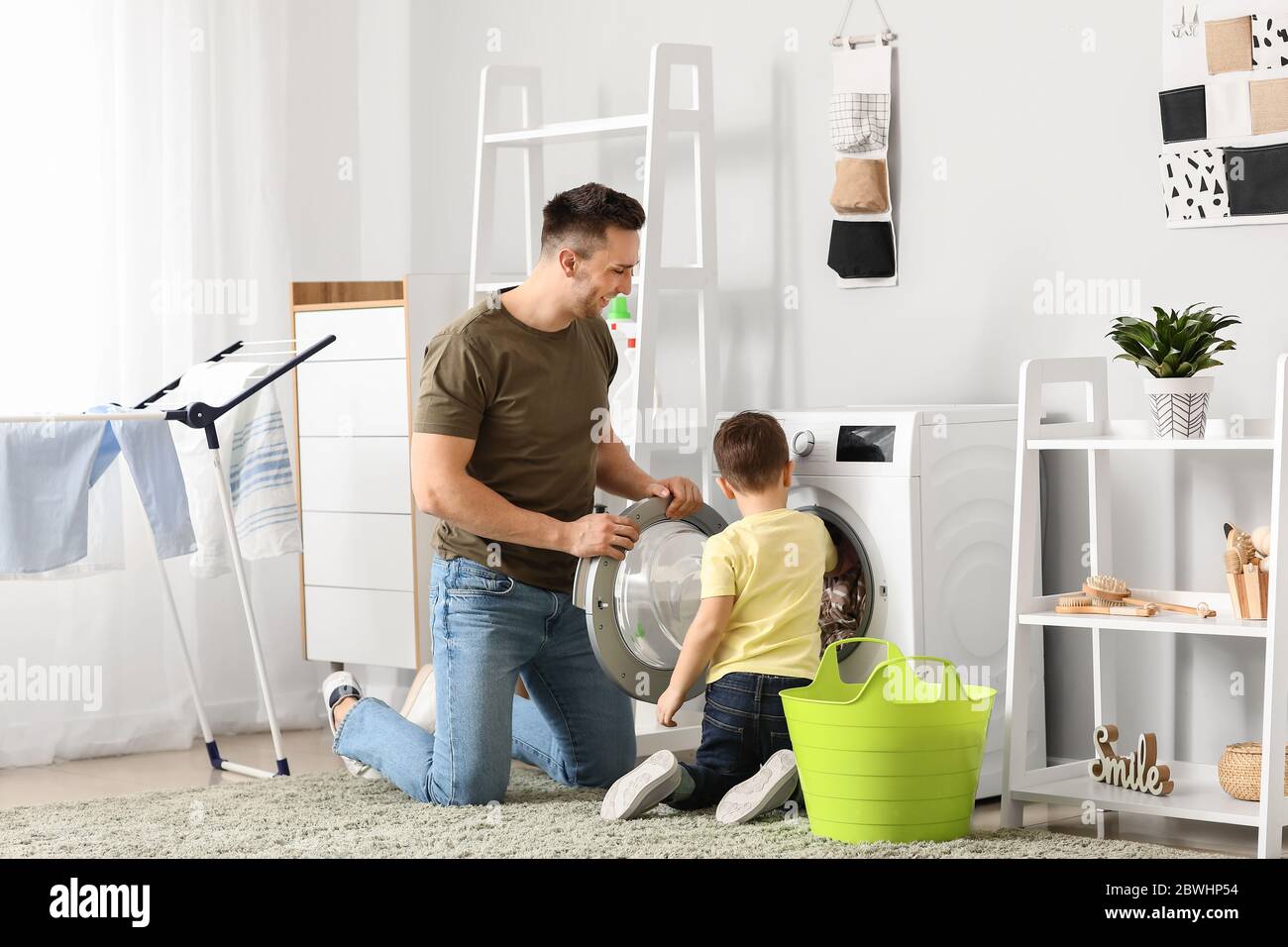 Boy doing laundry hi-res stock photography and images - Alamy