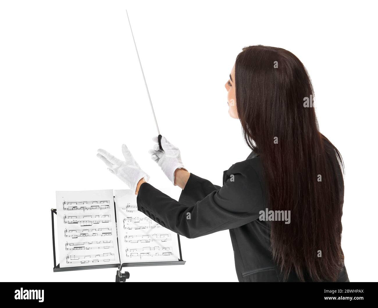 Young female conductor on white background Stock Photo - Alamy