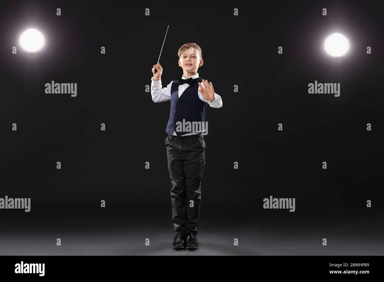 Little conductor on dark background Stock Photo - Alamy
