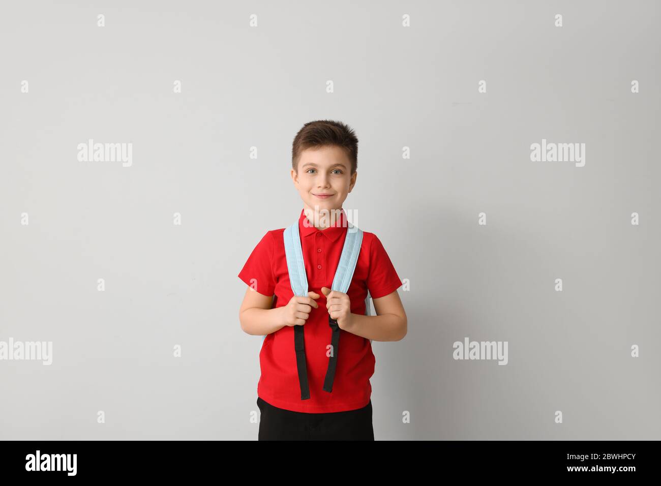 Cute little pupil on light background Stock Photo - Alamy
