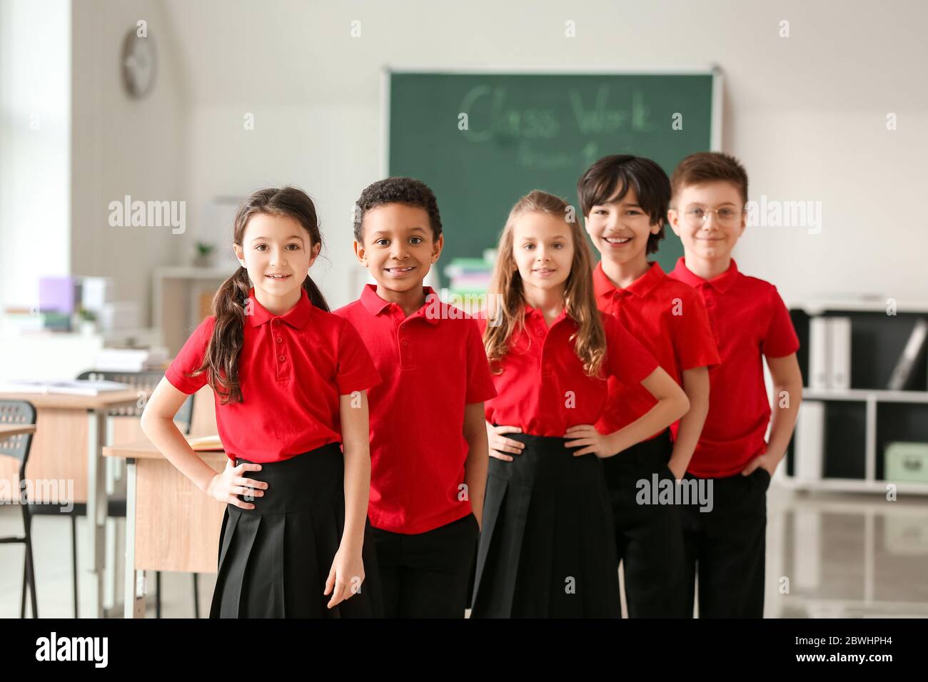 Cute little pupils in classroom Stock Photo - Alamy