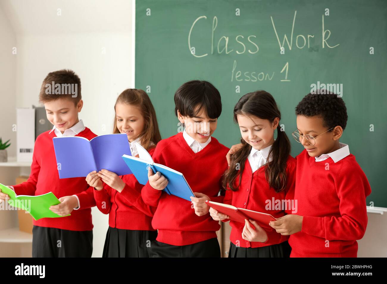 Cute little pupils in classroom Stock Photo - Alamy