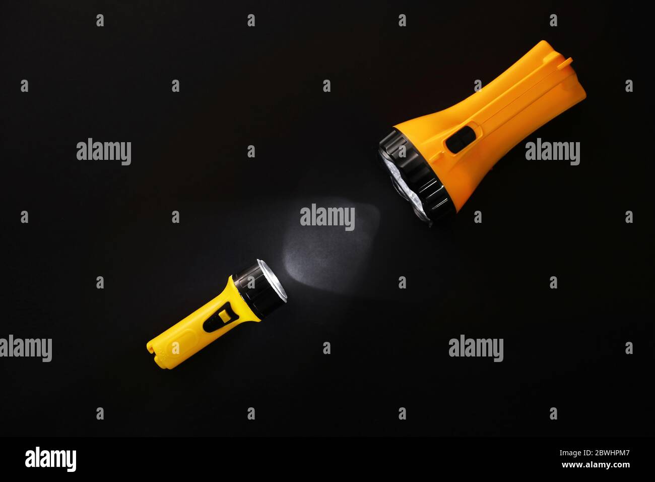 Modern flashlights on dark background Stock Photo - Alamy