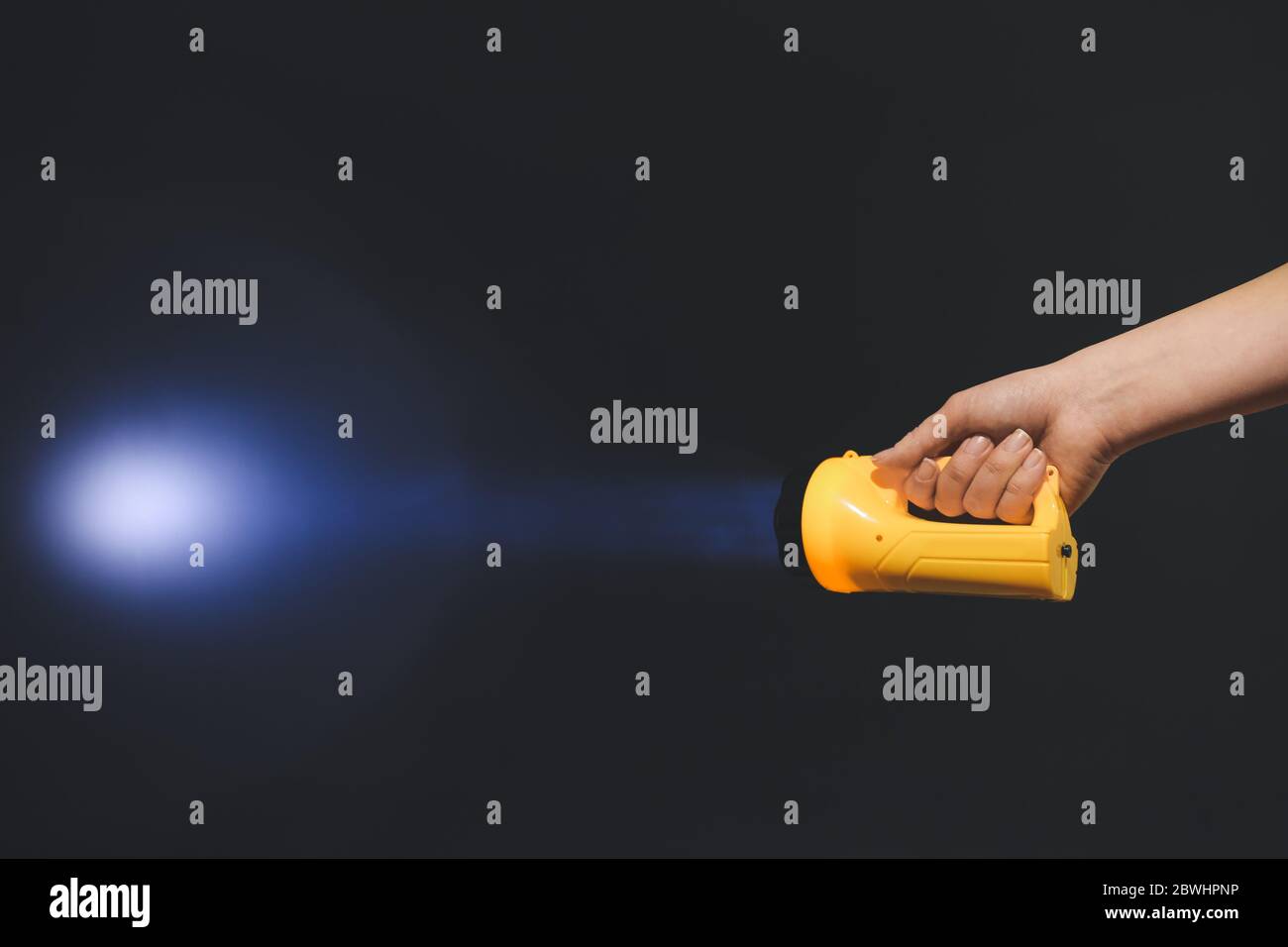 Female hand with modern flashlight on dark background Stock Photo - Alamy