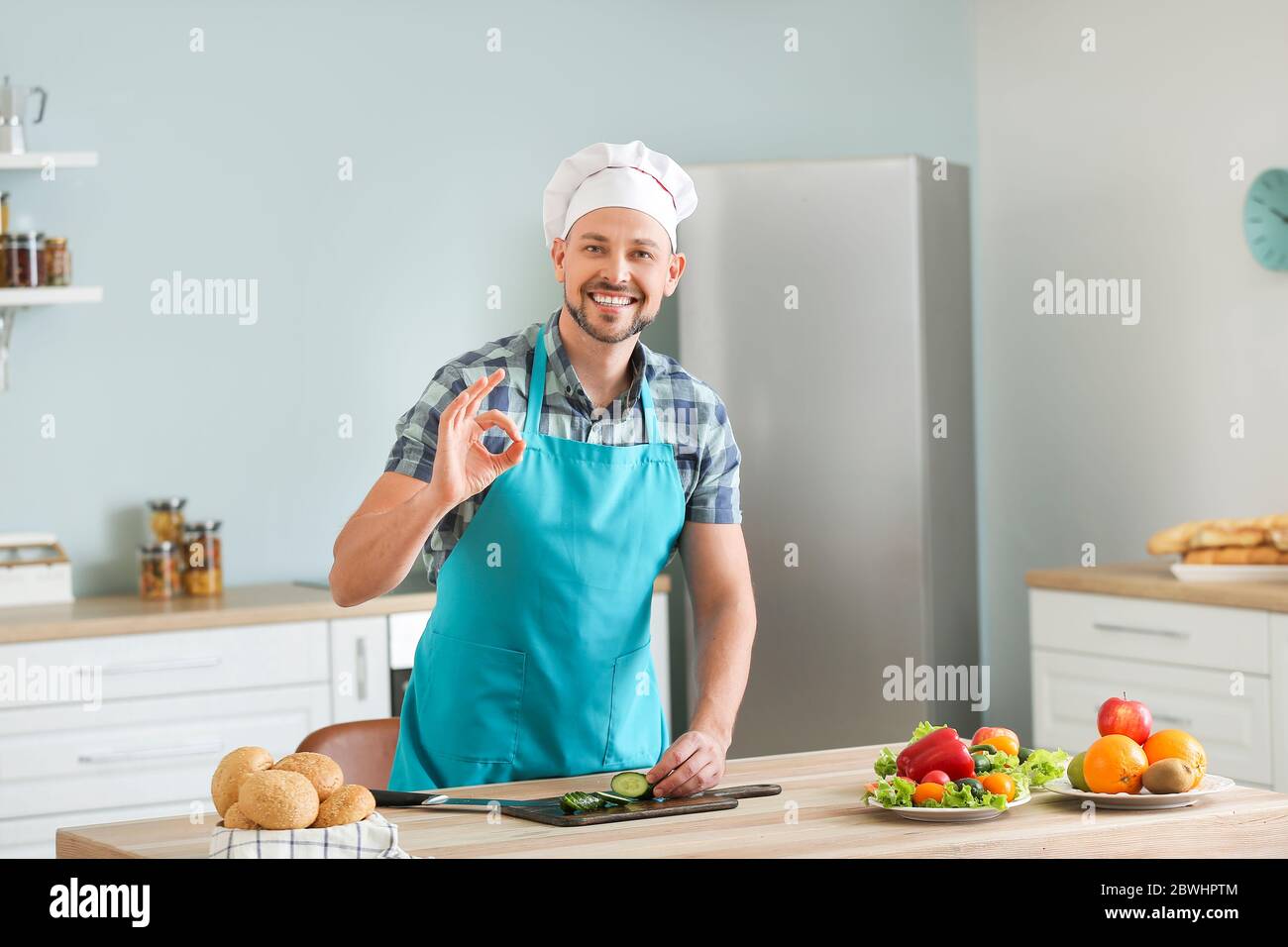 Handsome chef cooking in kitchen Stock Photo - Alamy
