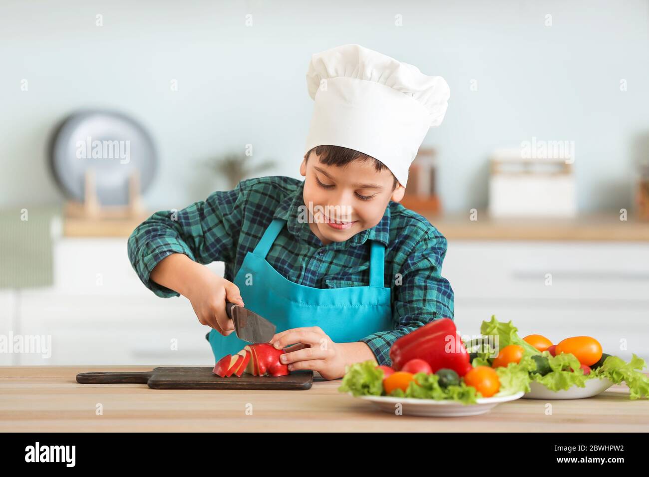 Cute little chef cooking in kitchen Stock Photo - Alamy