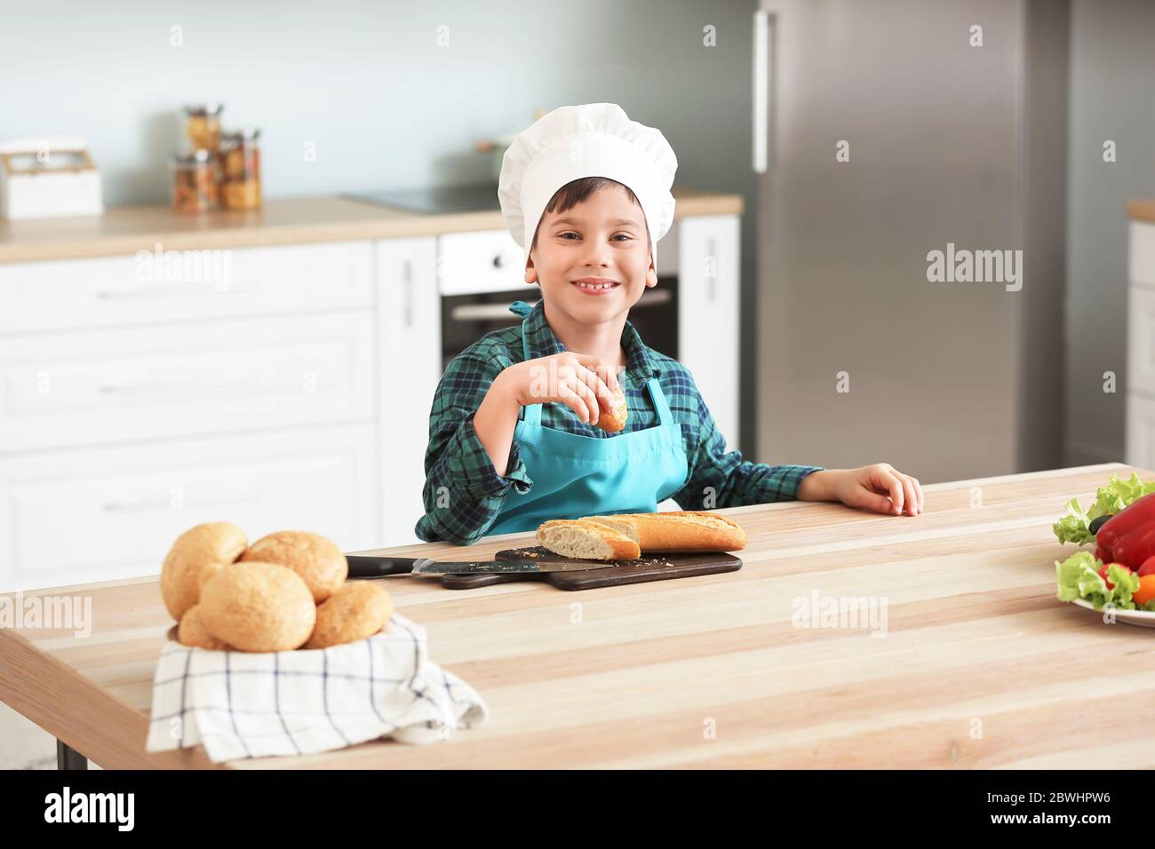 Cute little chef cooking in kitchen Stock Photo - Alamy