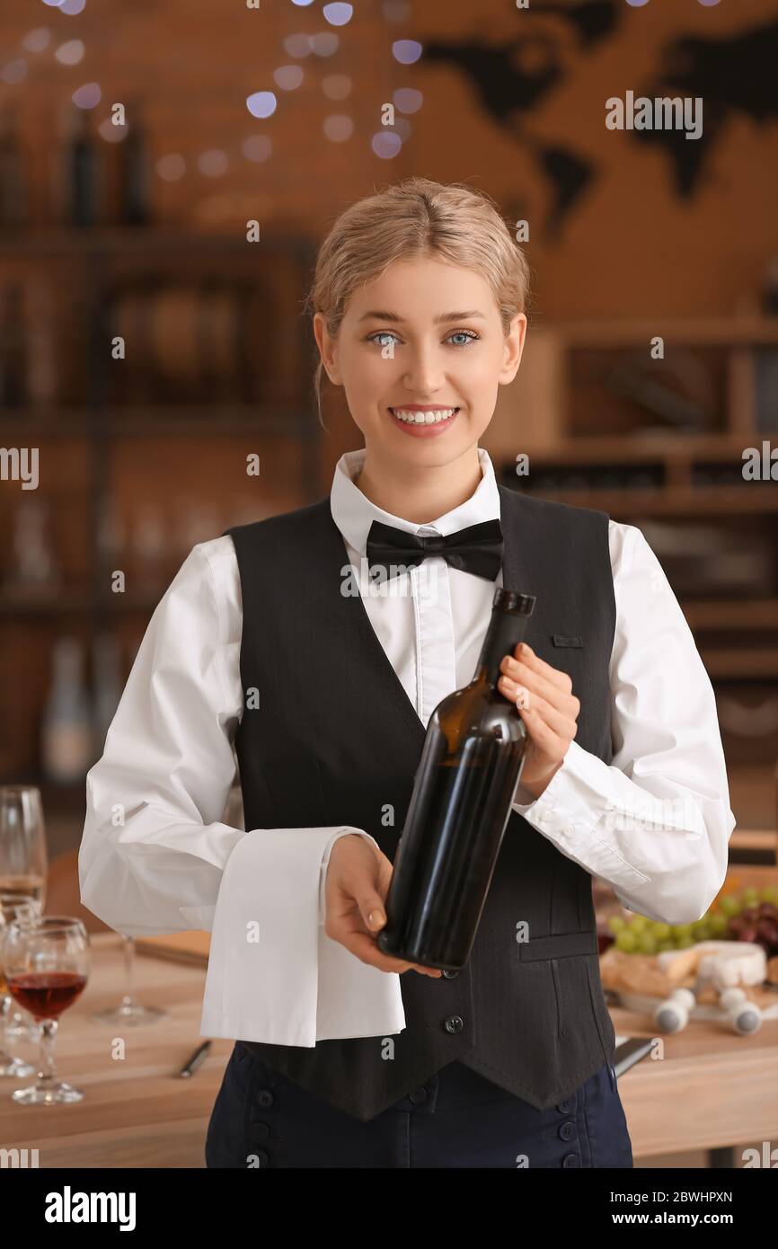 Waiter with bottle of wine at the restaurant Stock Photo - Alamy