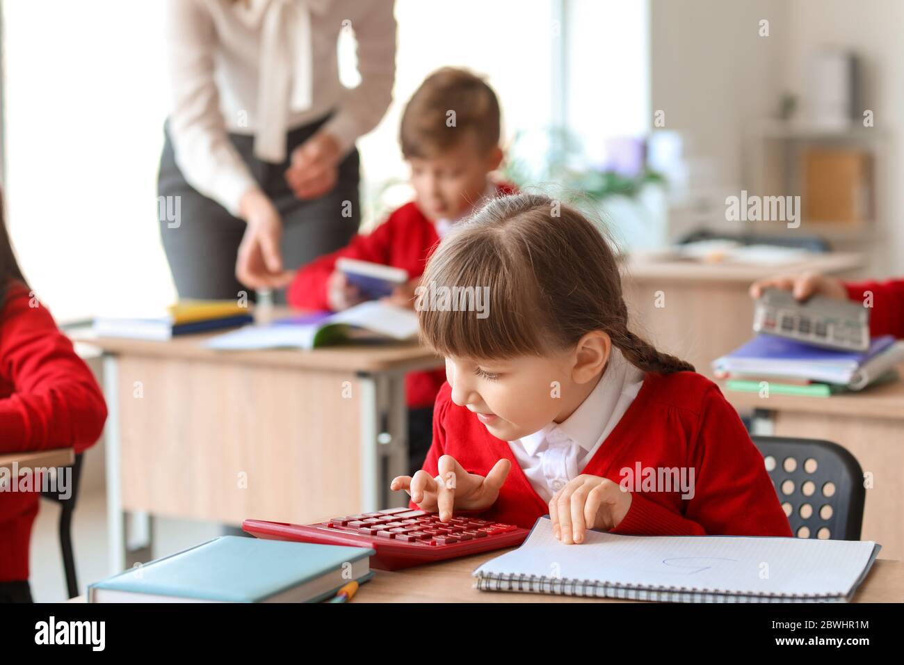 Little girl doing math task in classroom Stock Photo - Alamy
