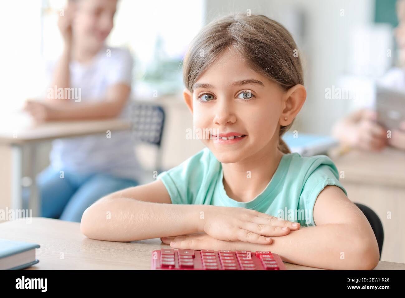 Little girl doing math task in classroom Stock Photo - Alamy