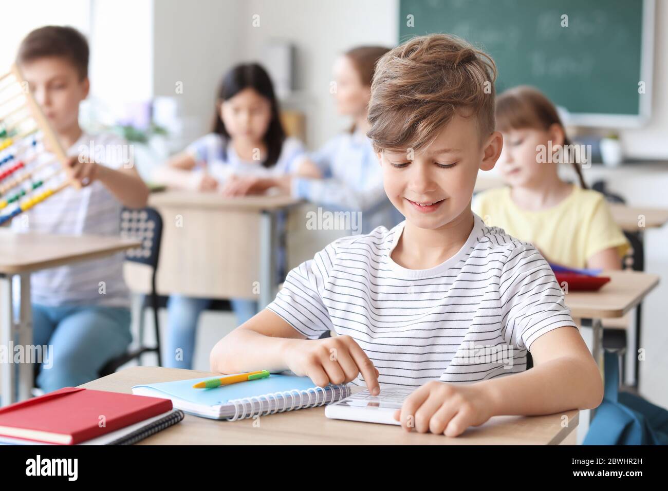 Little boy doing math task in classroom Stock Photo - Alamy