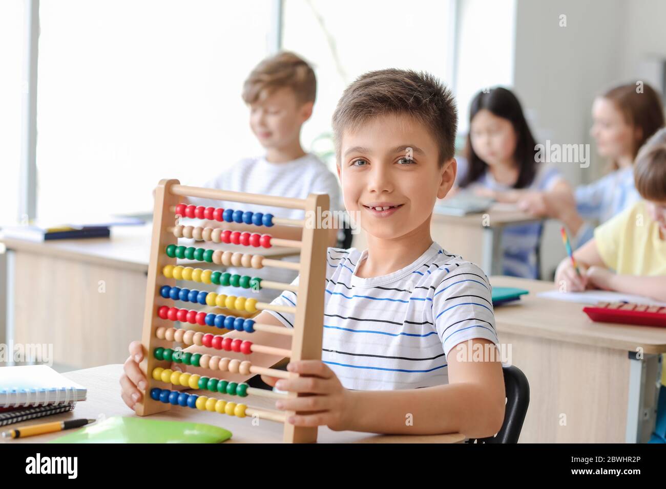 Little boy doing math task in classroom Stock Photo - Alamy