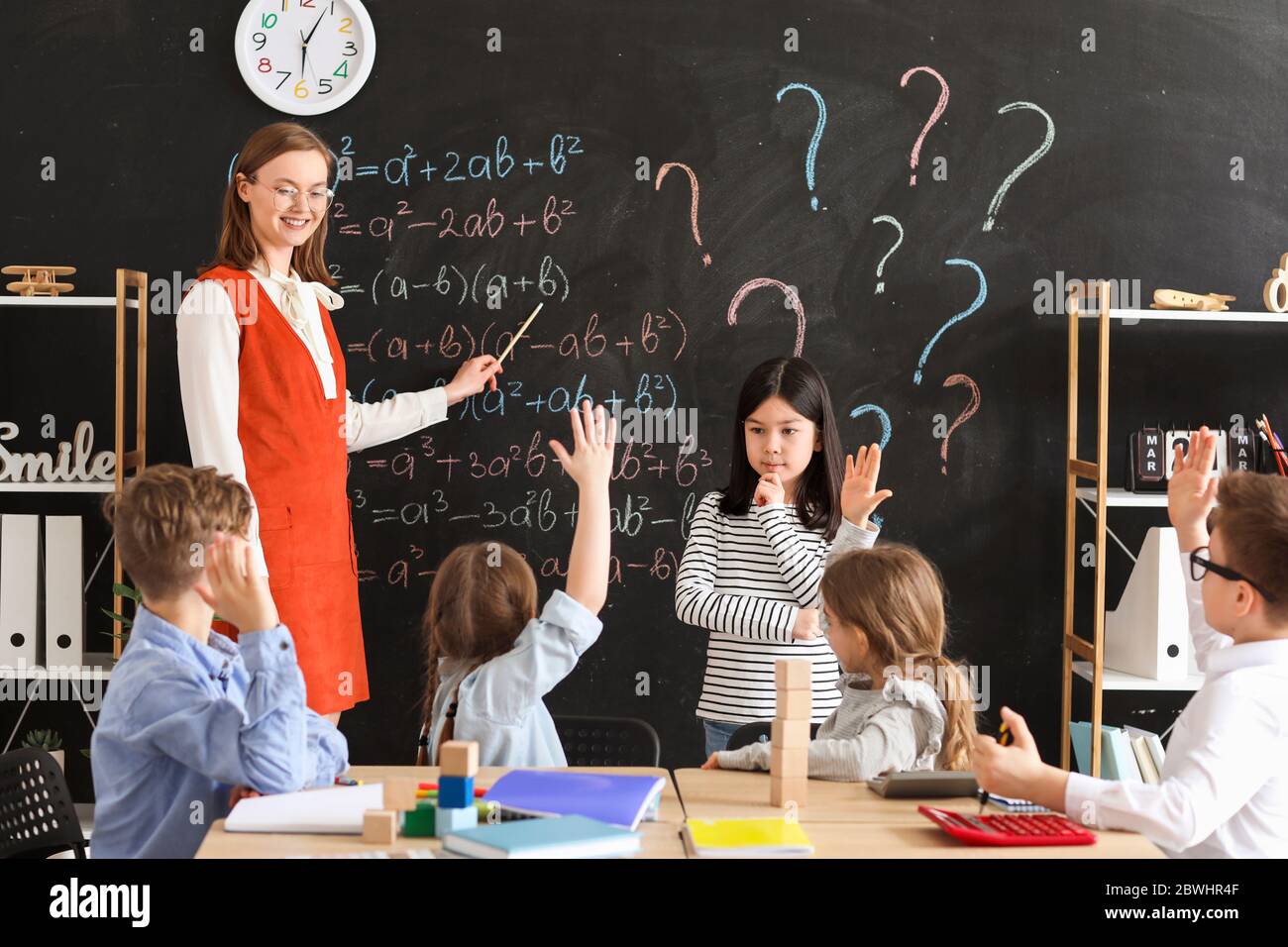 Math teacher conducting lesson in classroom Stock Photo - Alamy